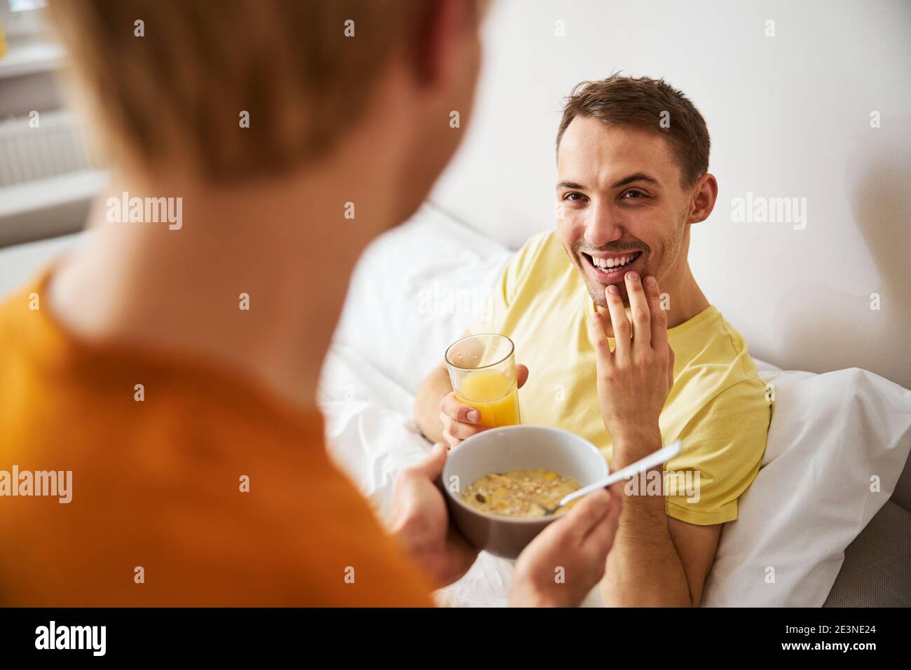 Loving young man bringing delicious breakfast to his boyfriend Stock ...