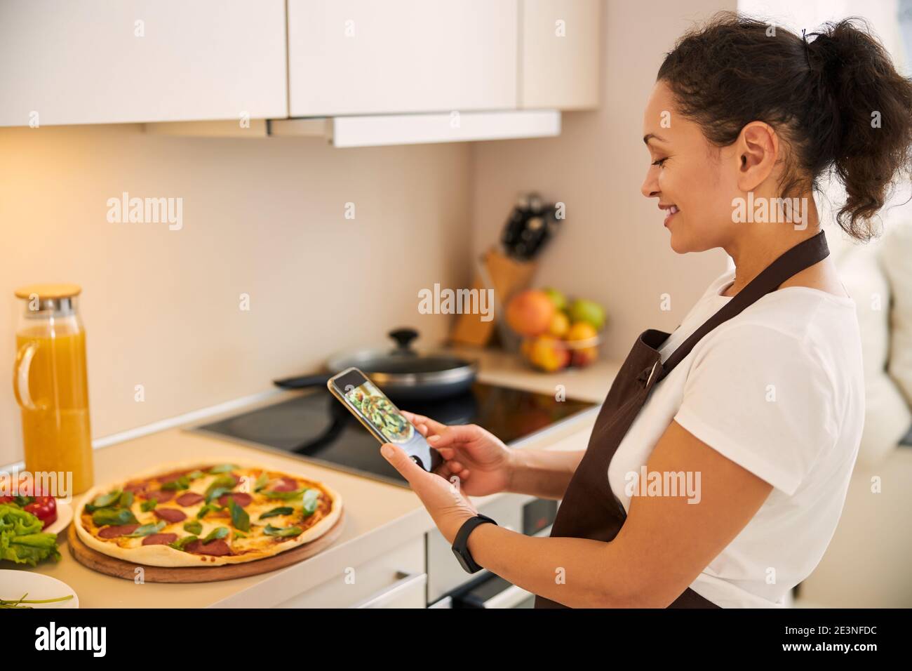 Positive young woman collecting memorable meals photo Stock Photo - Alamy