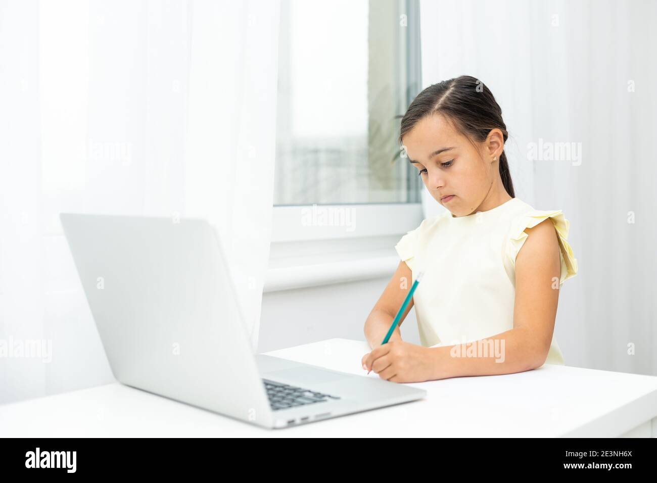 cheerful young little girl children using laptop computer, studying ...
