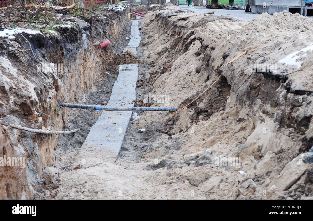 An excavated trench with underground cables, electricity and ...