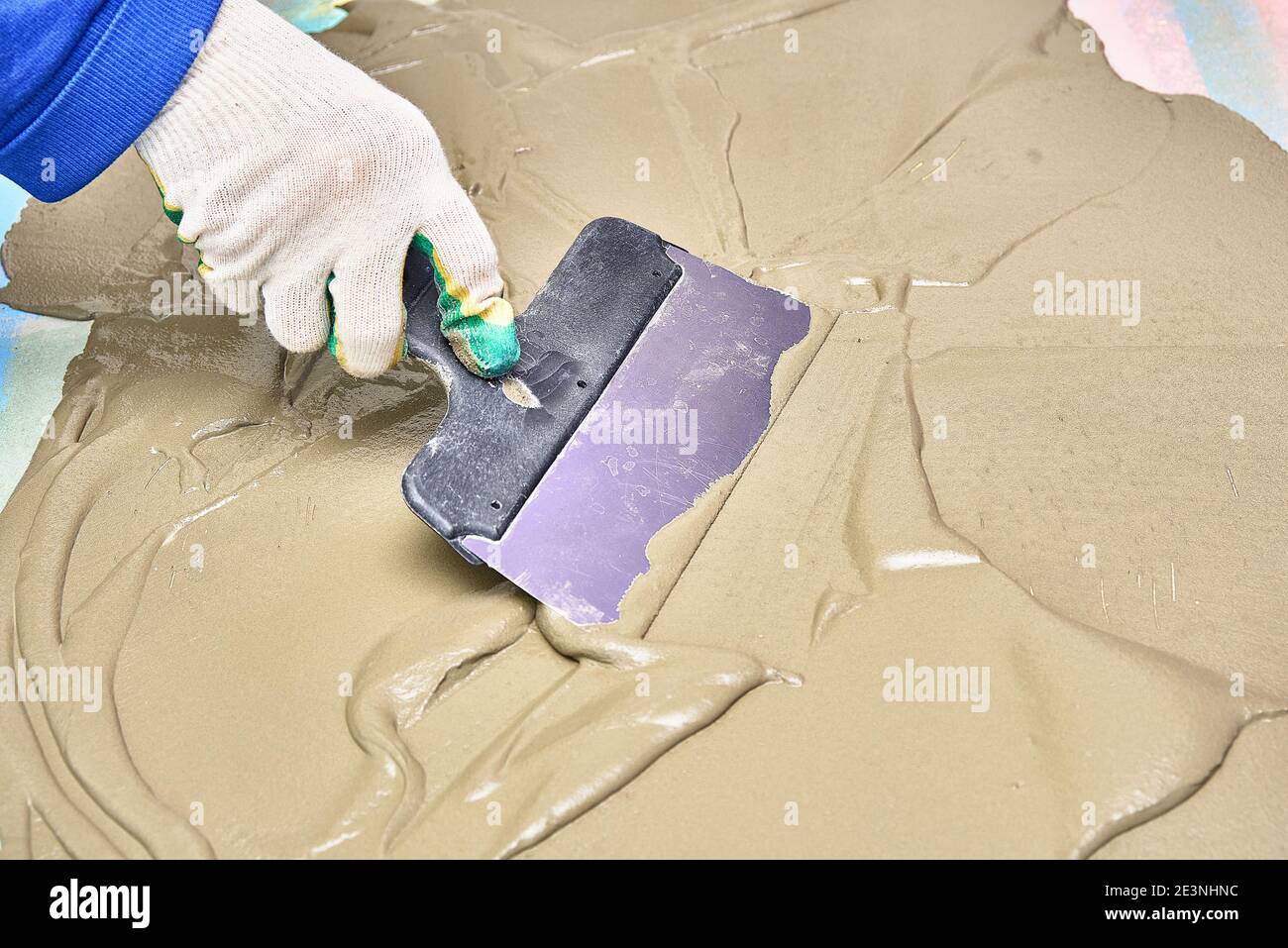 worker in gloves puts plaster with spatula. repair, construction Stock ...