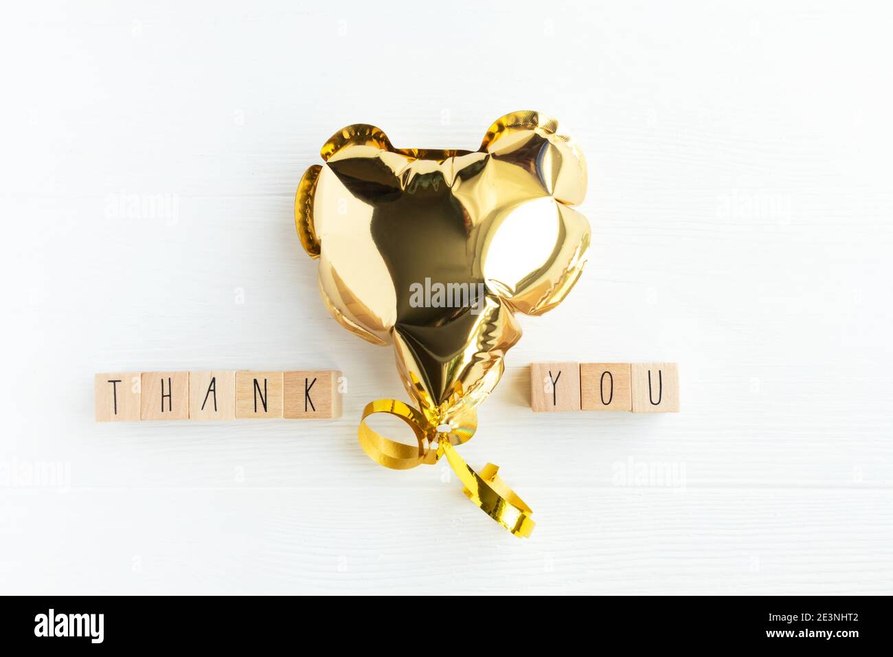 The word thank you on wooden cubes and a heart shaped balloon on a ...