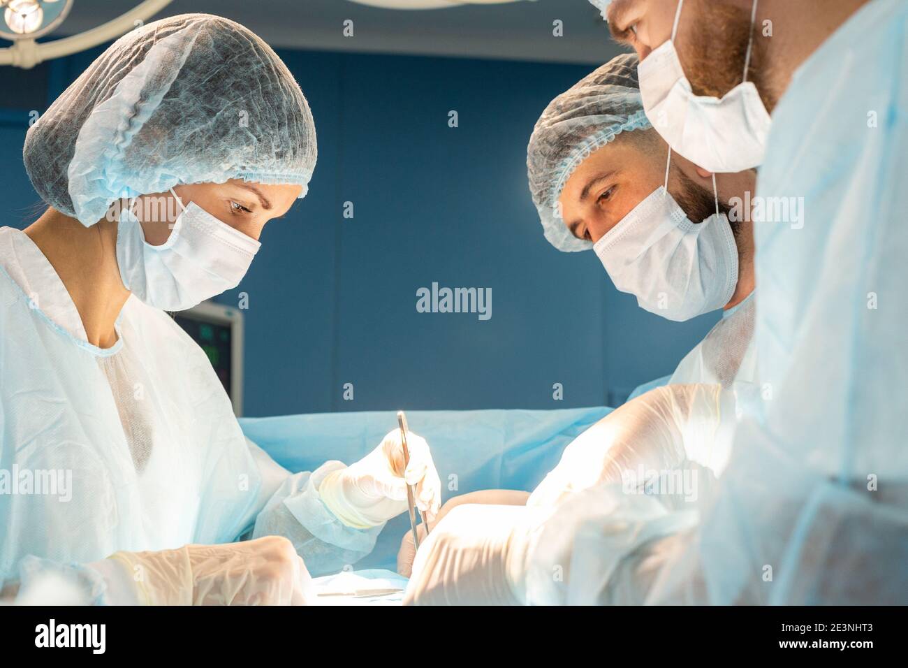 An international team of doctors performs a complex surgical operation ...