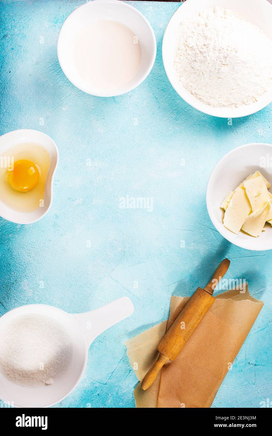 Baking ingredients on a blue table background. Ingredients for baking a ...
