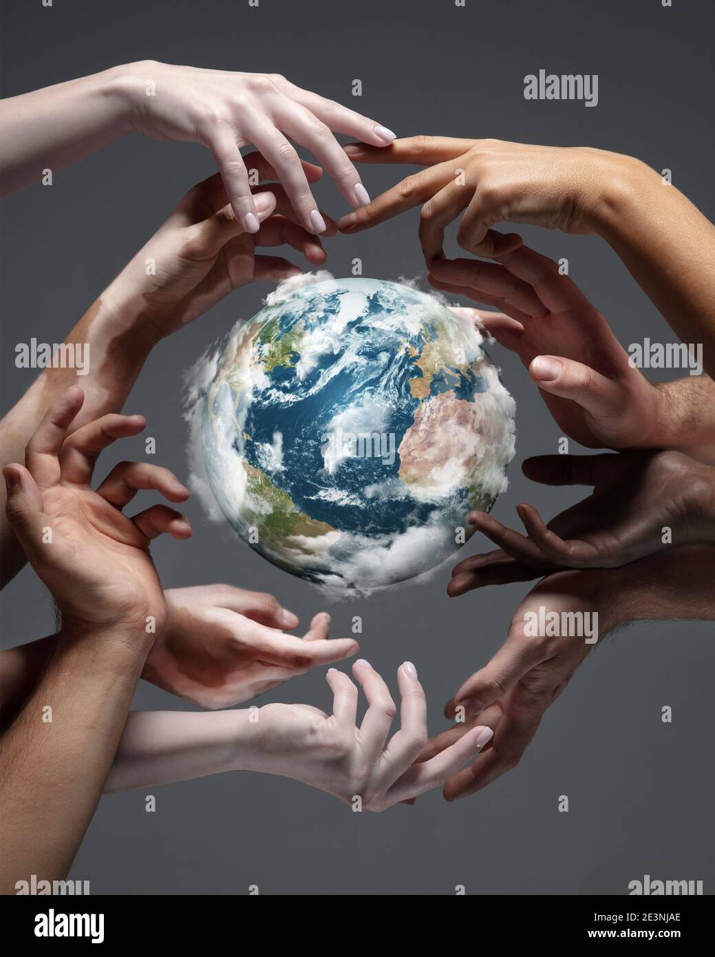 Hands holding, touching planet Earth, close up on grey background ...