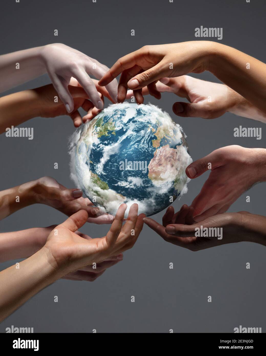 Hands holding, touching planet Earth, close up on grey background ...