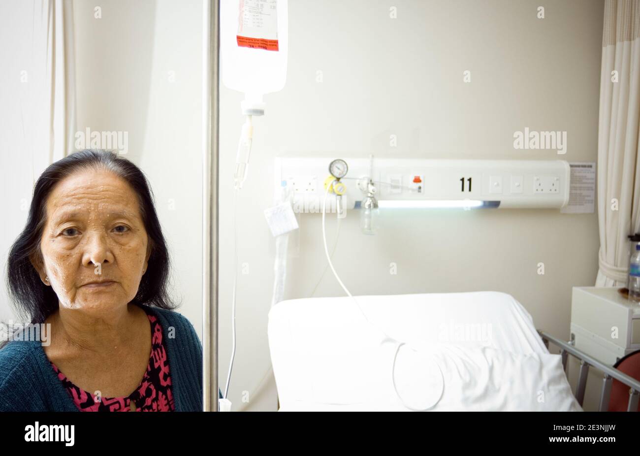 A Southeast Old Asian Woman Sitting on Hospital Bed Being Bored and ...