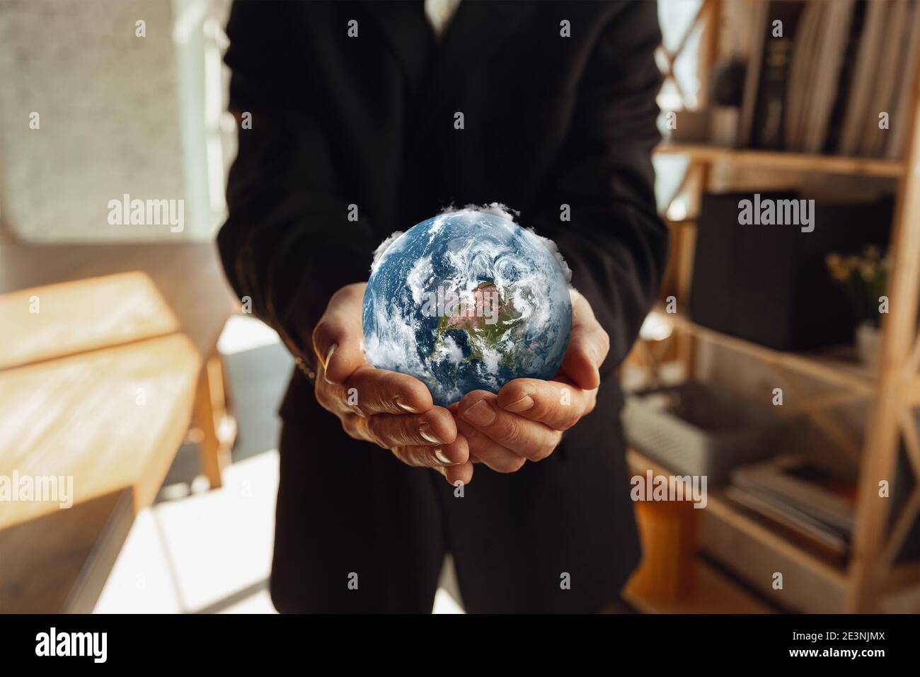 Hands holding planet Earth, close up. Environment save, taking care of ...