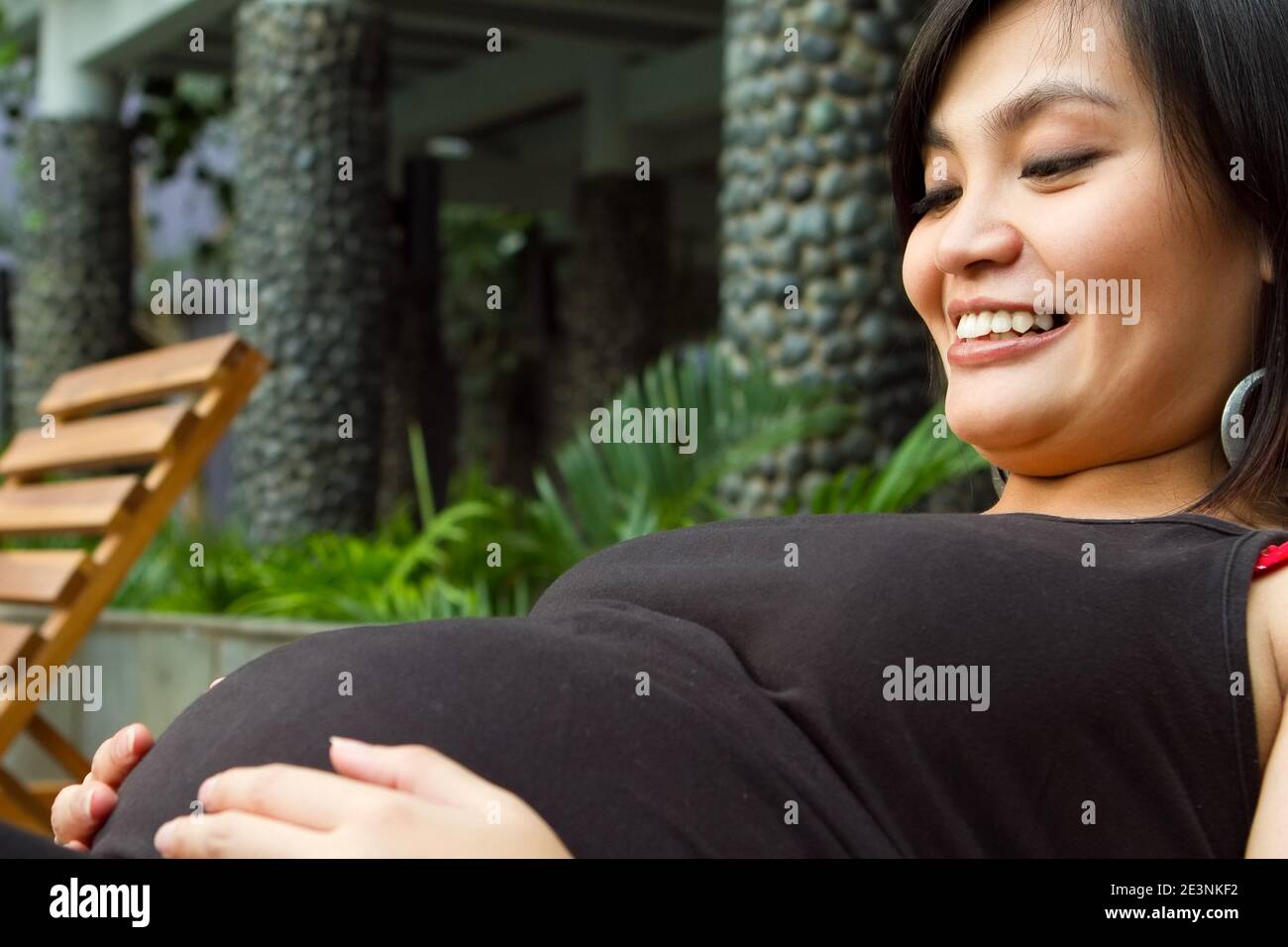 Happy Asian pregnant woman relaxing Stock Photo - Alamy
