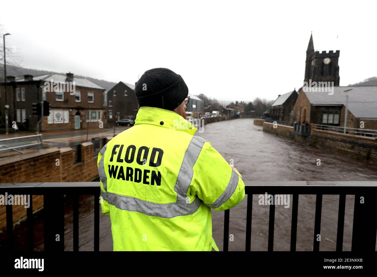 A flood warden looks at the water levels of the River Calder in ...