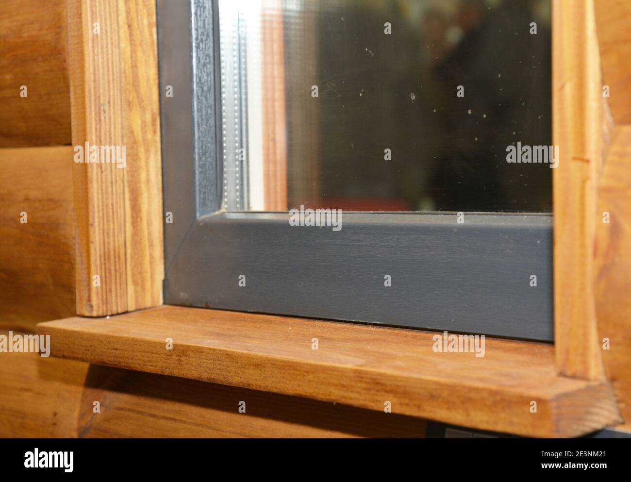 A wooden window sill with a upvc plastic window installed in a house ...
