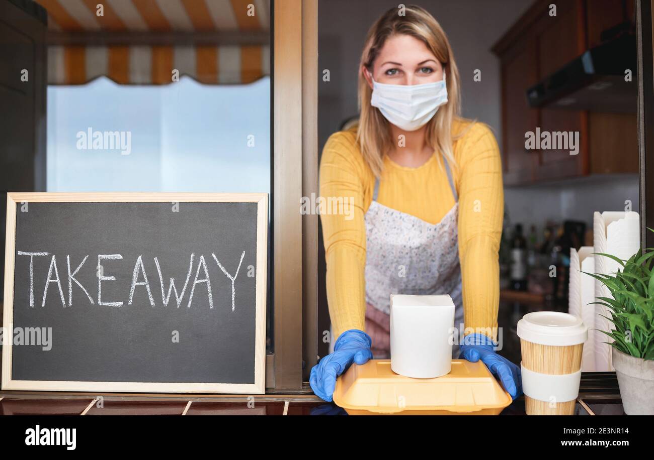 Young woman delivering takeaway organic food inside restaurant during ...