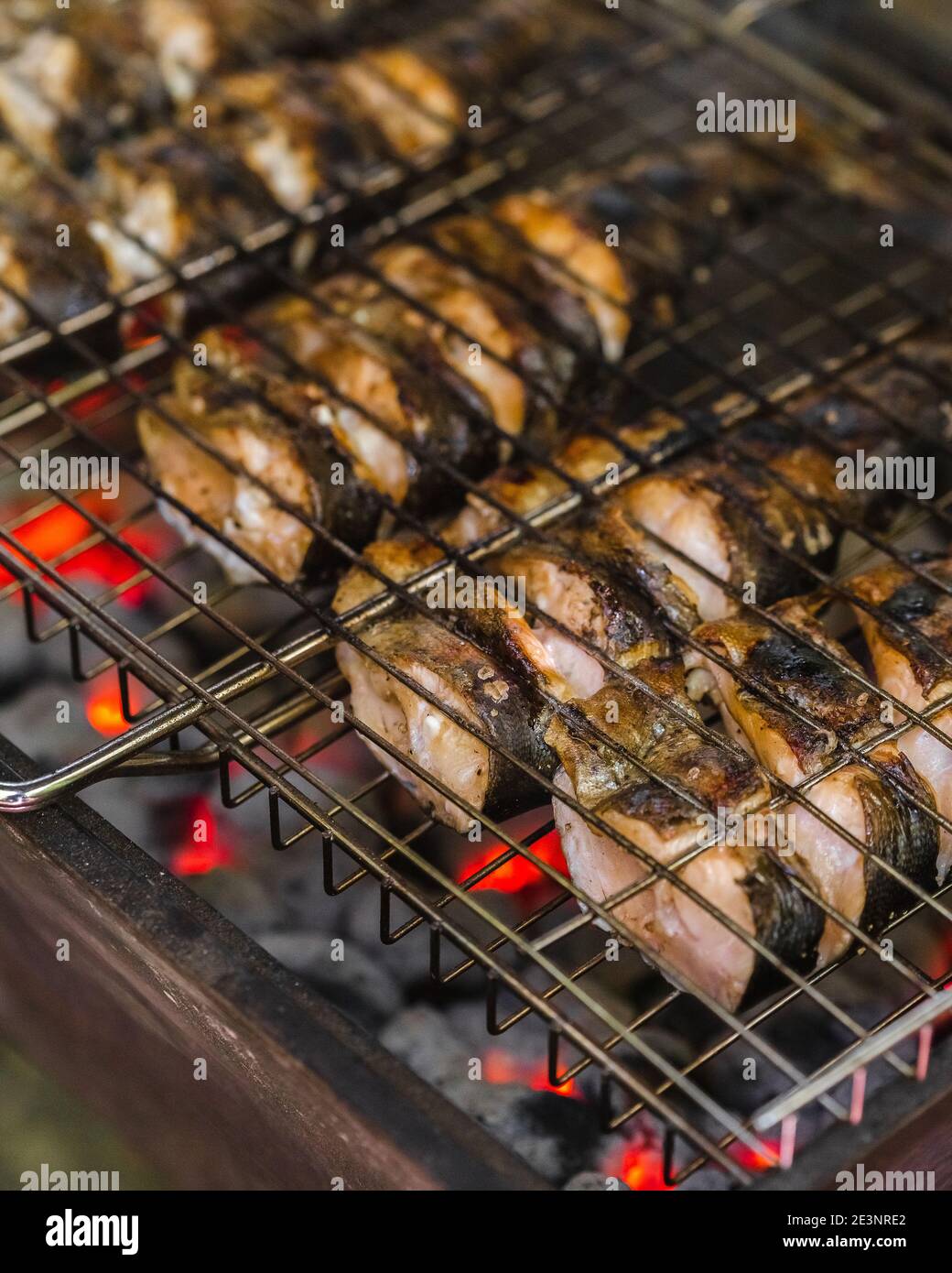 Fried trout fish on charcoal grill. Roasted fish pieces on fire Stock ...