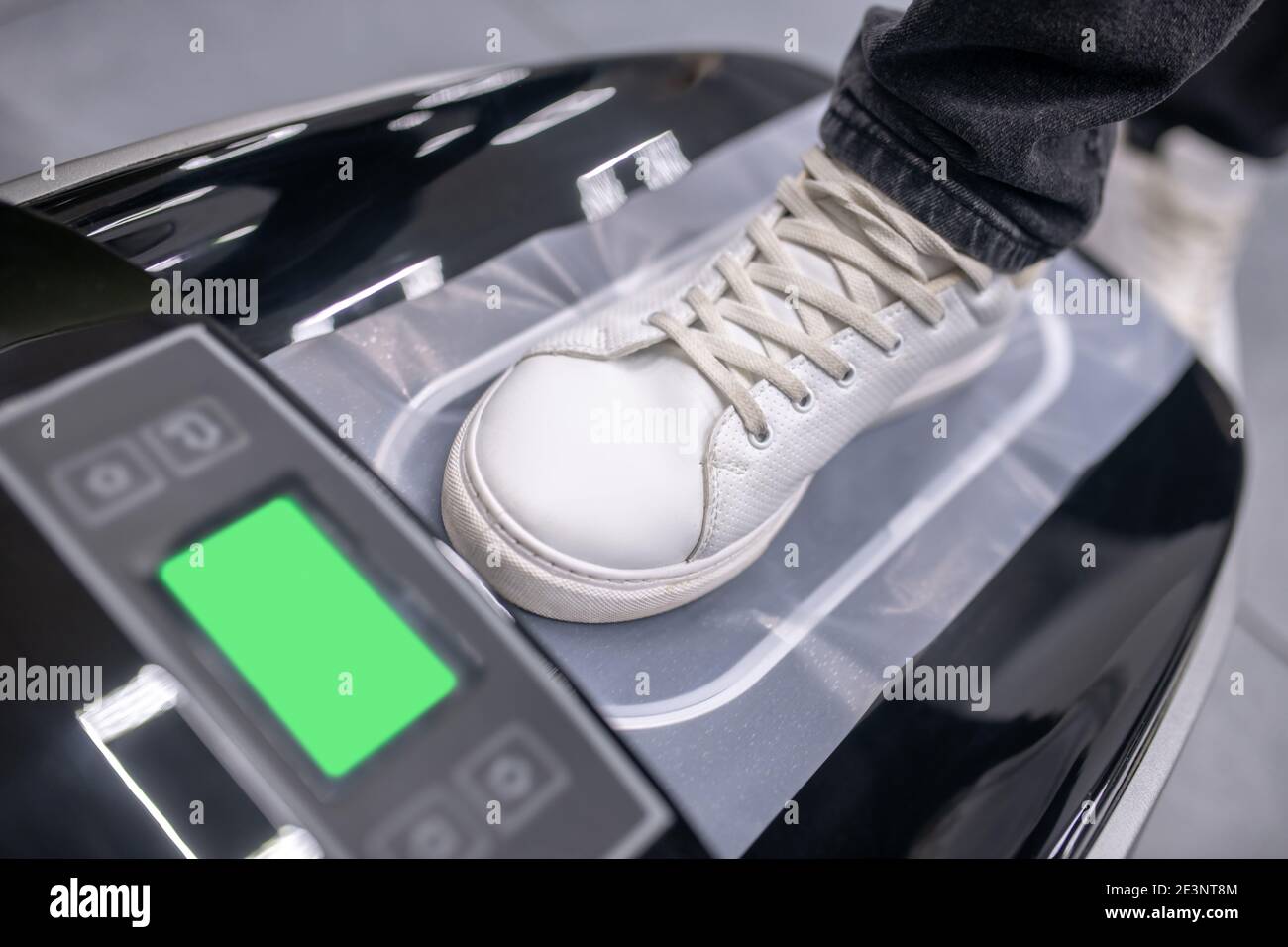 Foot in sneaker on electronic device with thermal film Stock Photo - Alamy