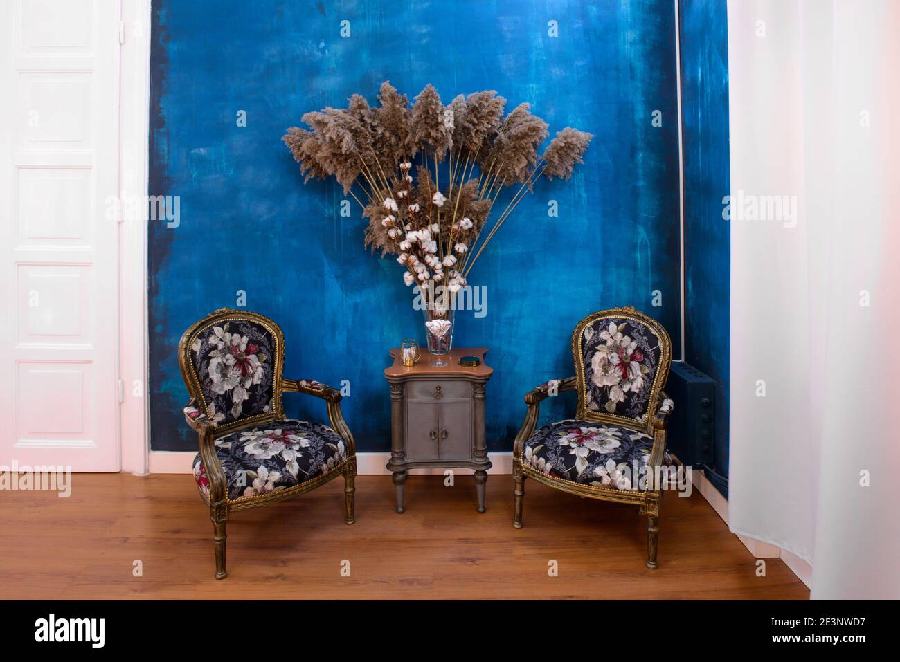 Avant-garde renovated room with two chairs and an old cupboard Stock ...
