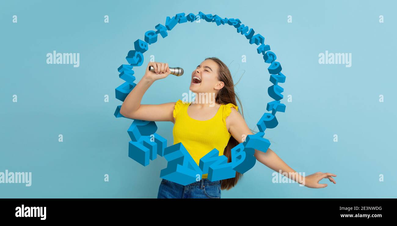 Young girl shouting, singing with microphone, loudspeaker on blue ...