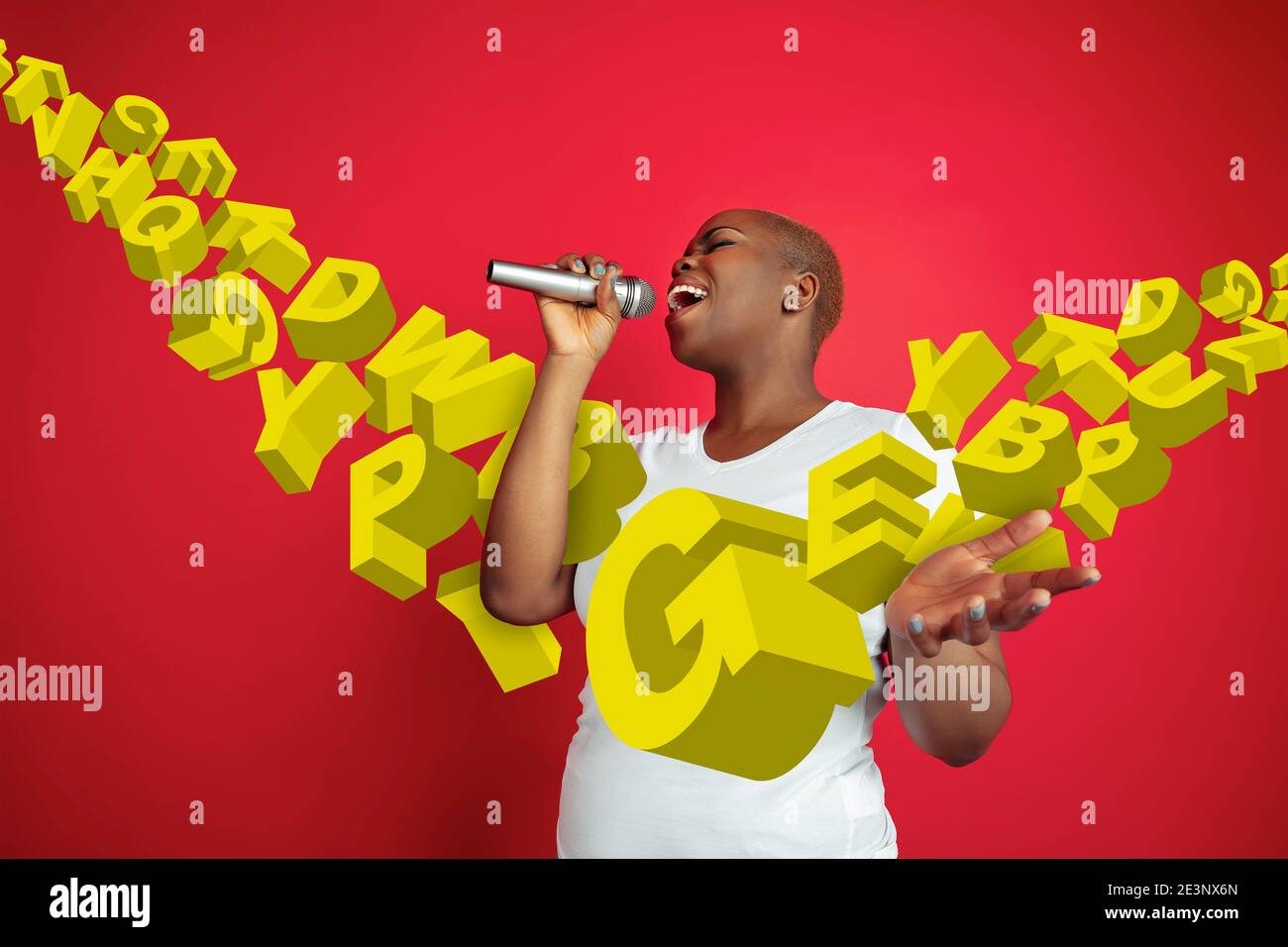 Young woman shouting, singing with microphone, loudspeaker on red ...