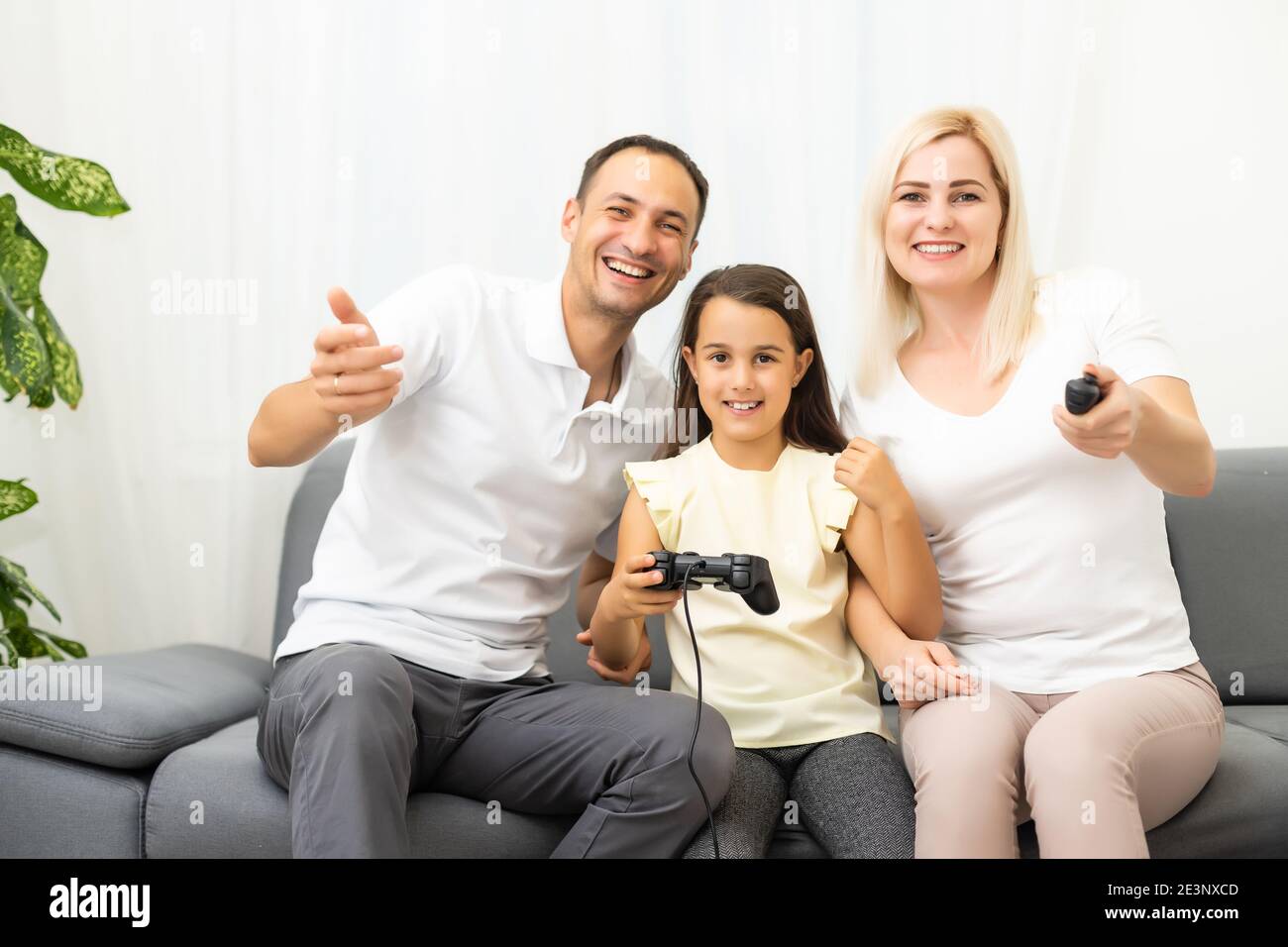 Happy family playing video games at home and having fun together Stock ...