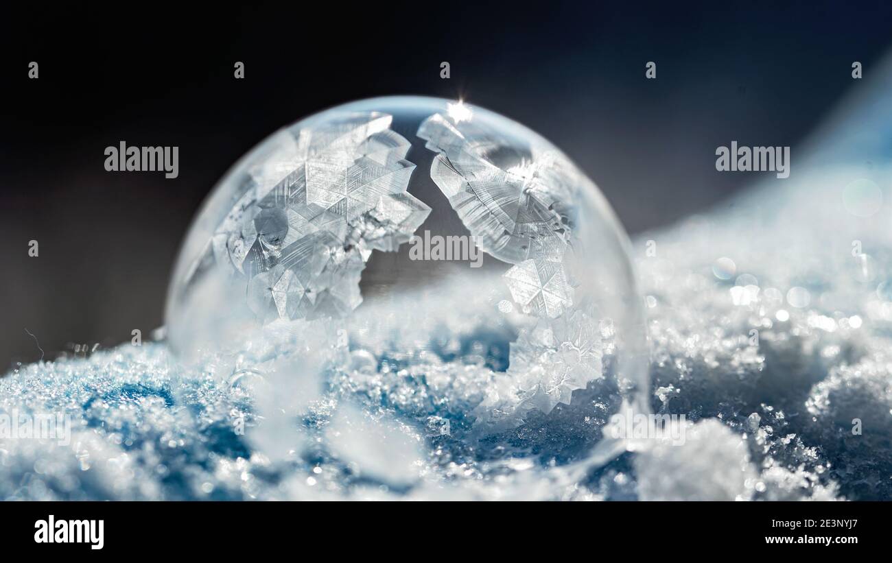 frozen bubble with bokeh background. Beautiful frosty patterns on ...