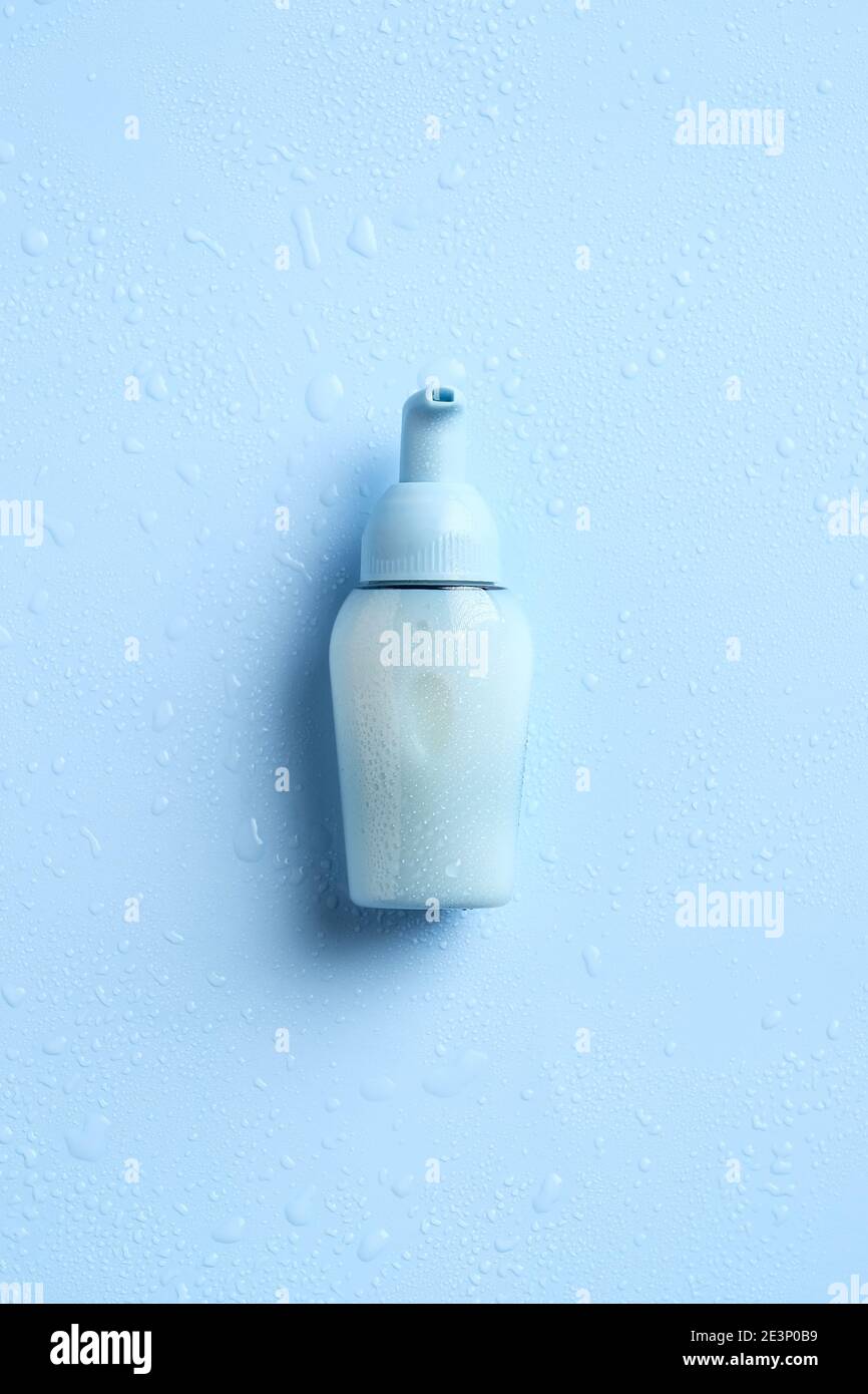 Cosmetic jar with moisturizing lotion on blue background. Water based ...