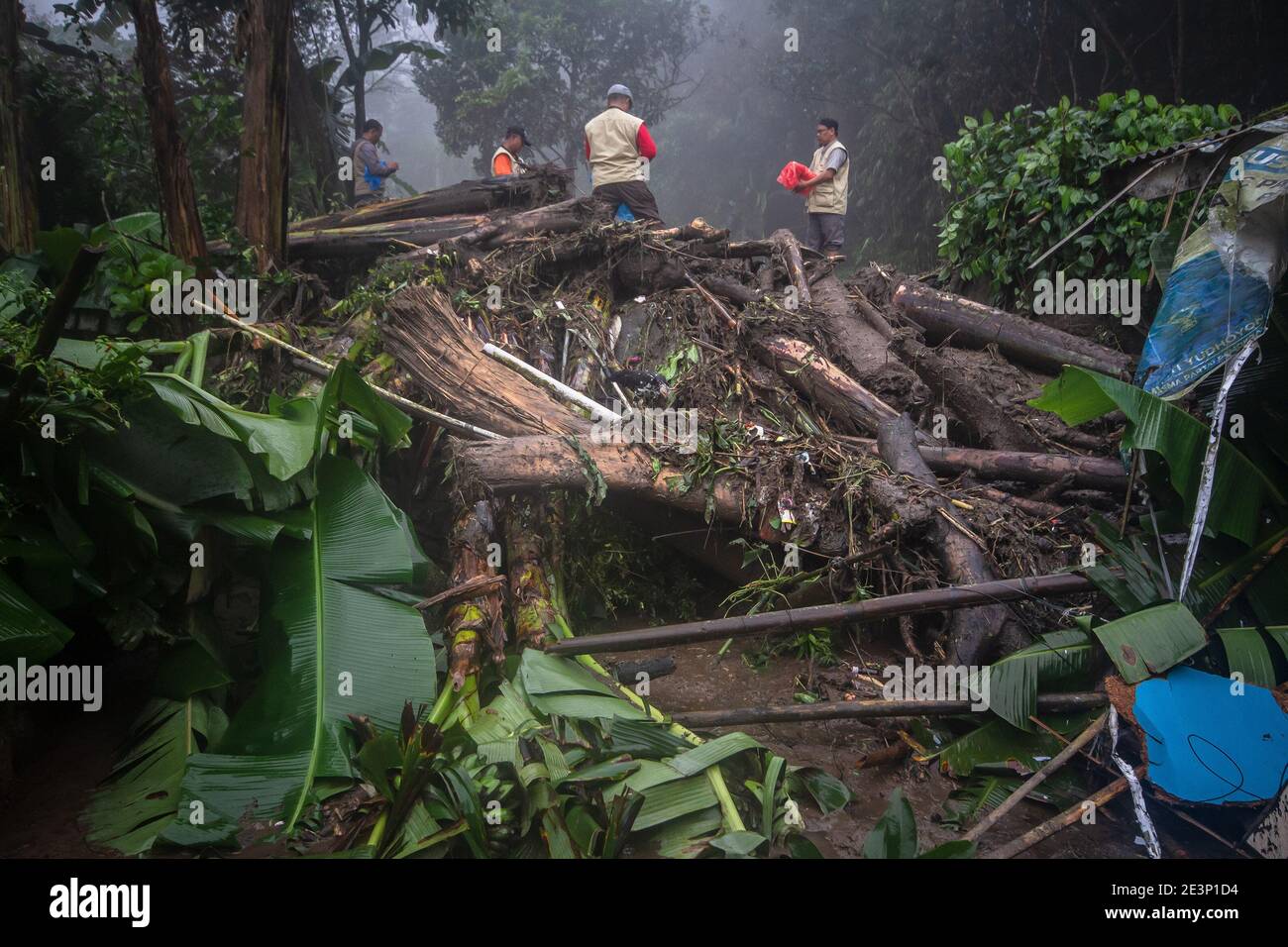 Bogor, West Java, Indonesia. 20th Jan, 2021. Residents clean up mud after flash floods in the ...