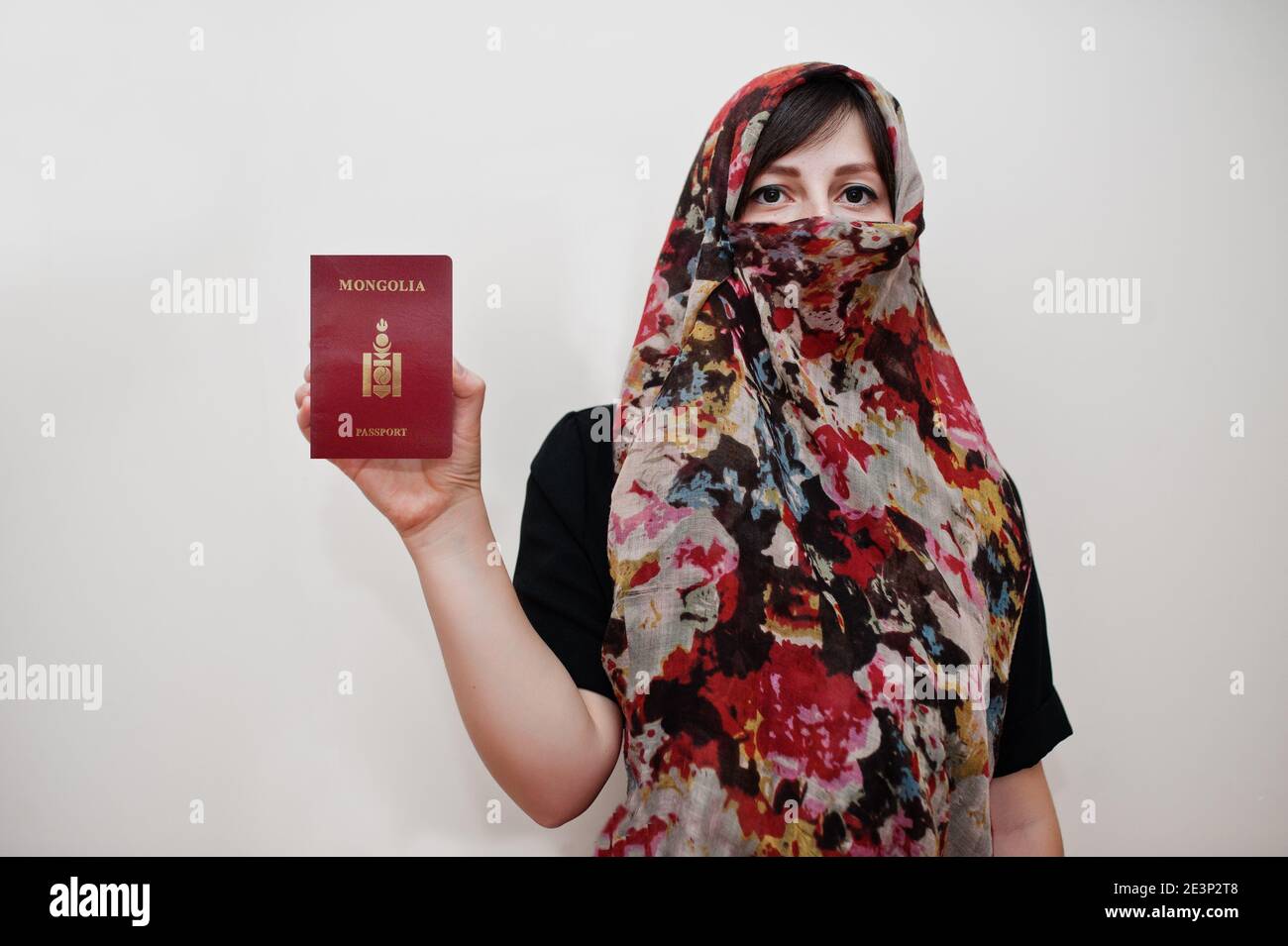Young arabian muslim woman in hijab clothes hold Mongolia passport on ...