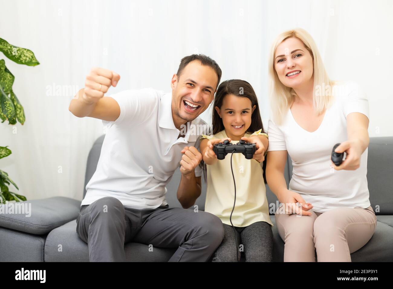 Happy family playing video games at home and having fun together Stock ...