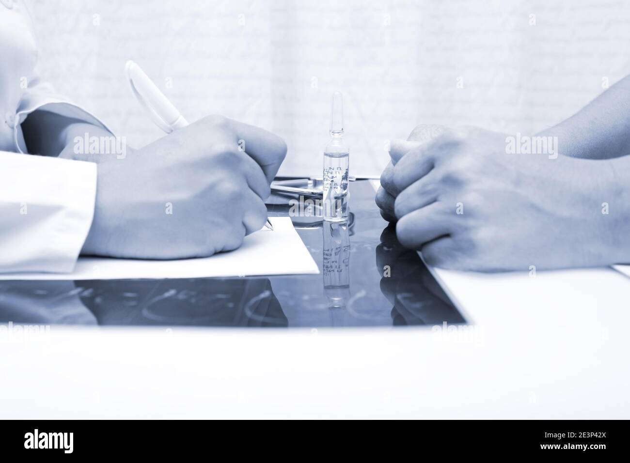 Doctor signs the treatment for the patient during medical appointment ...