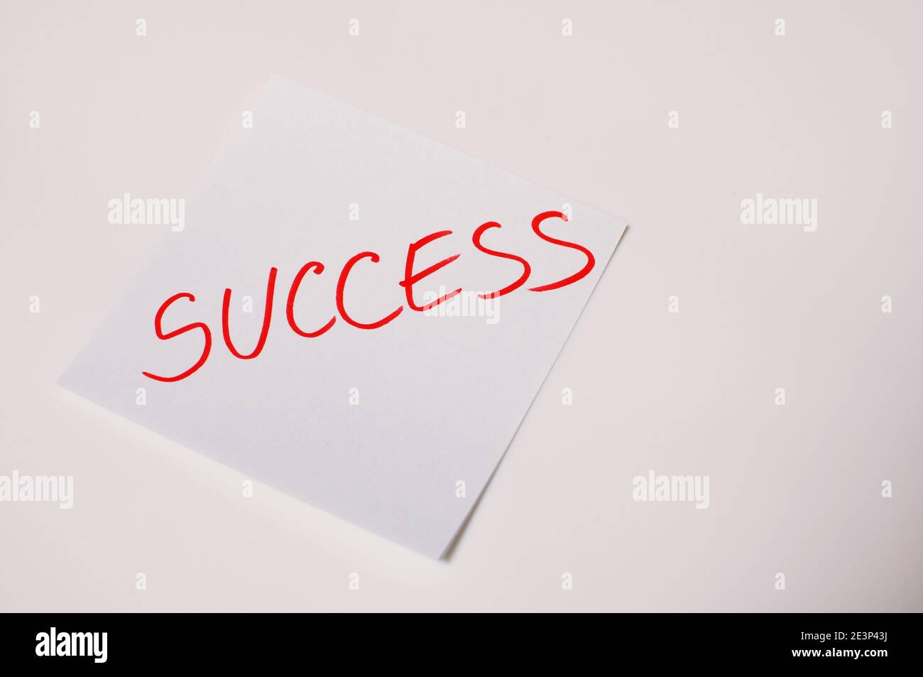 The word success written by hand and put on the white table with copy ...