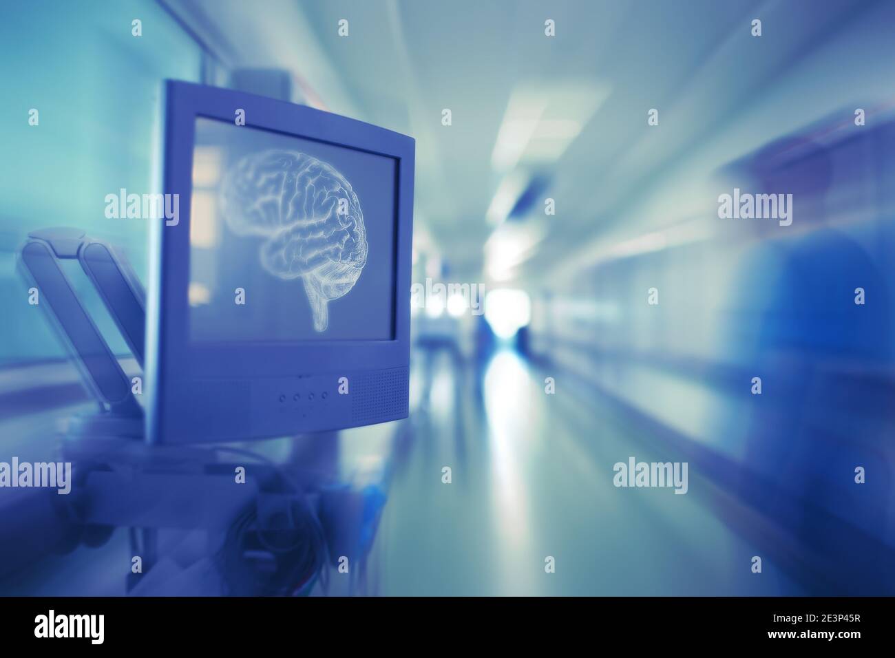 Monitor with brain image and blurred silhouette of doctor in the ...