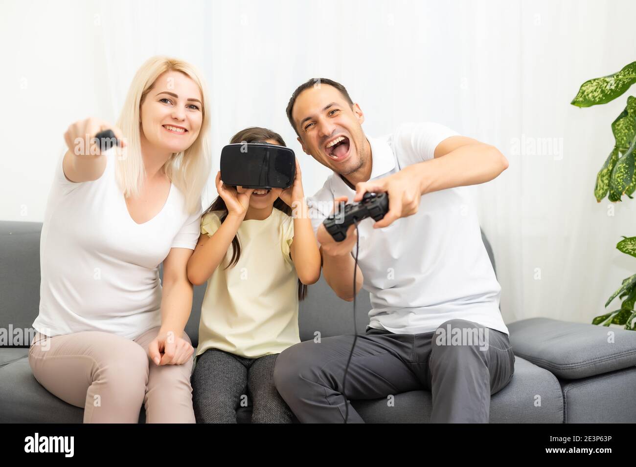 Happy family playing video games at home and having fun together Stock ...