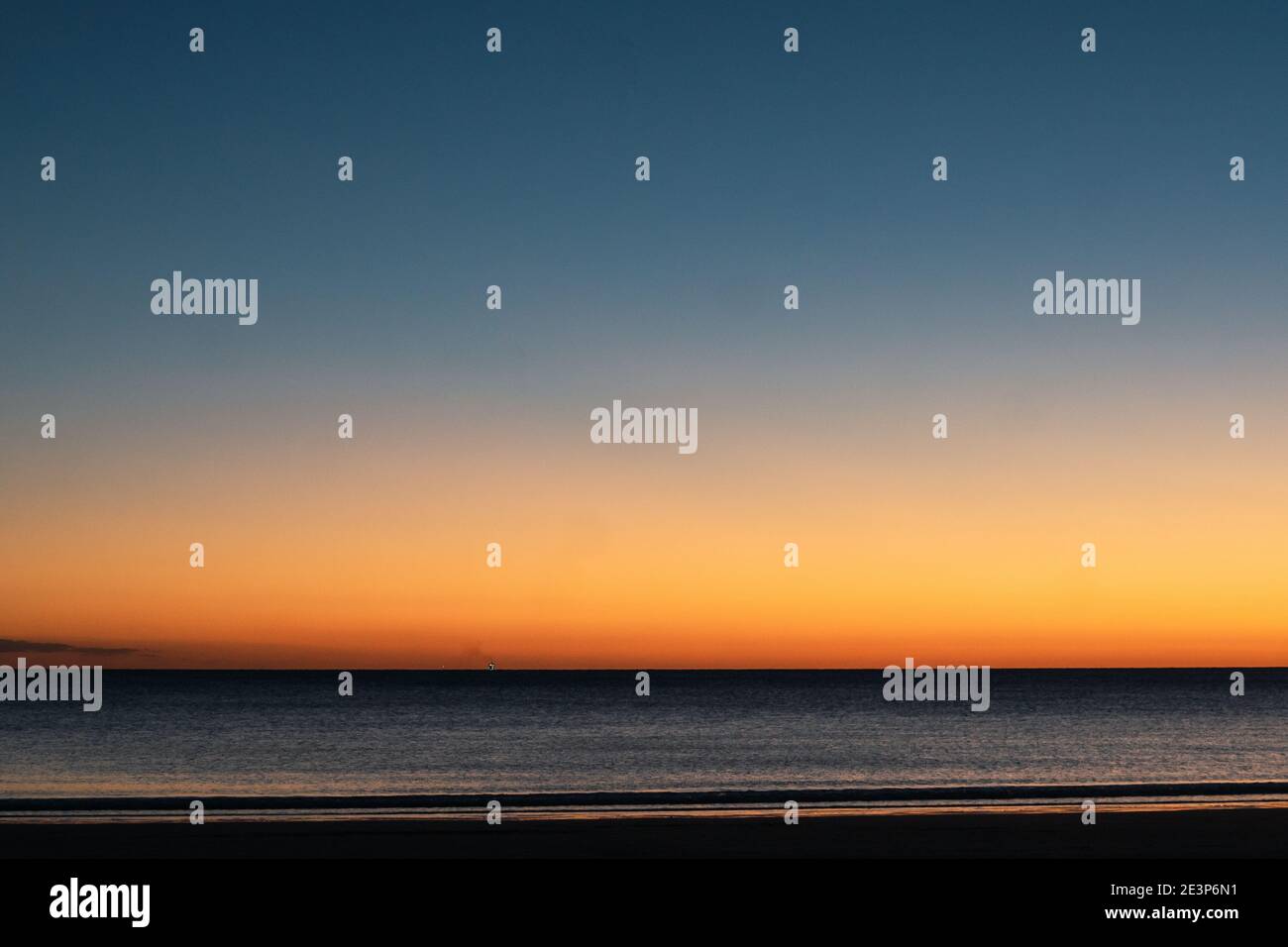 Last rays of sun at sunset and its reflection in the colorful sky and ...