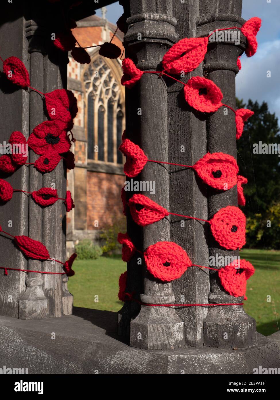 Knitted poppy flowers attached to church columns for remembrance day ...