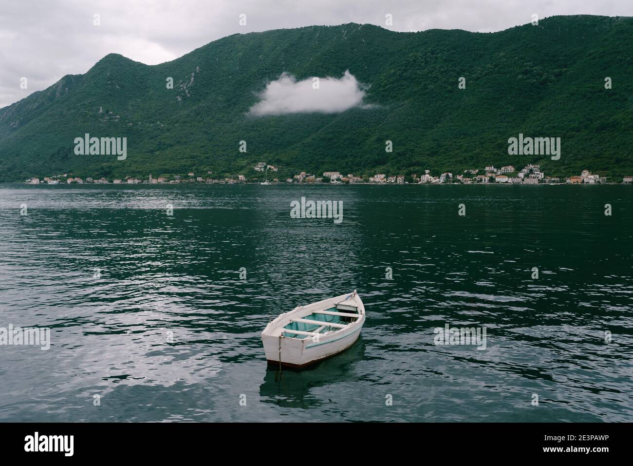 A small wooden boat with a white cloud hanging over it. Abstract ...