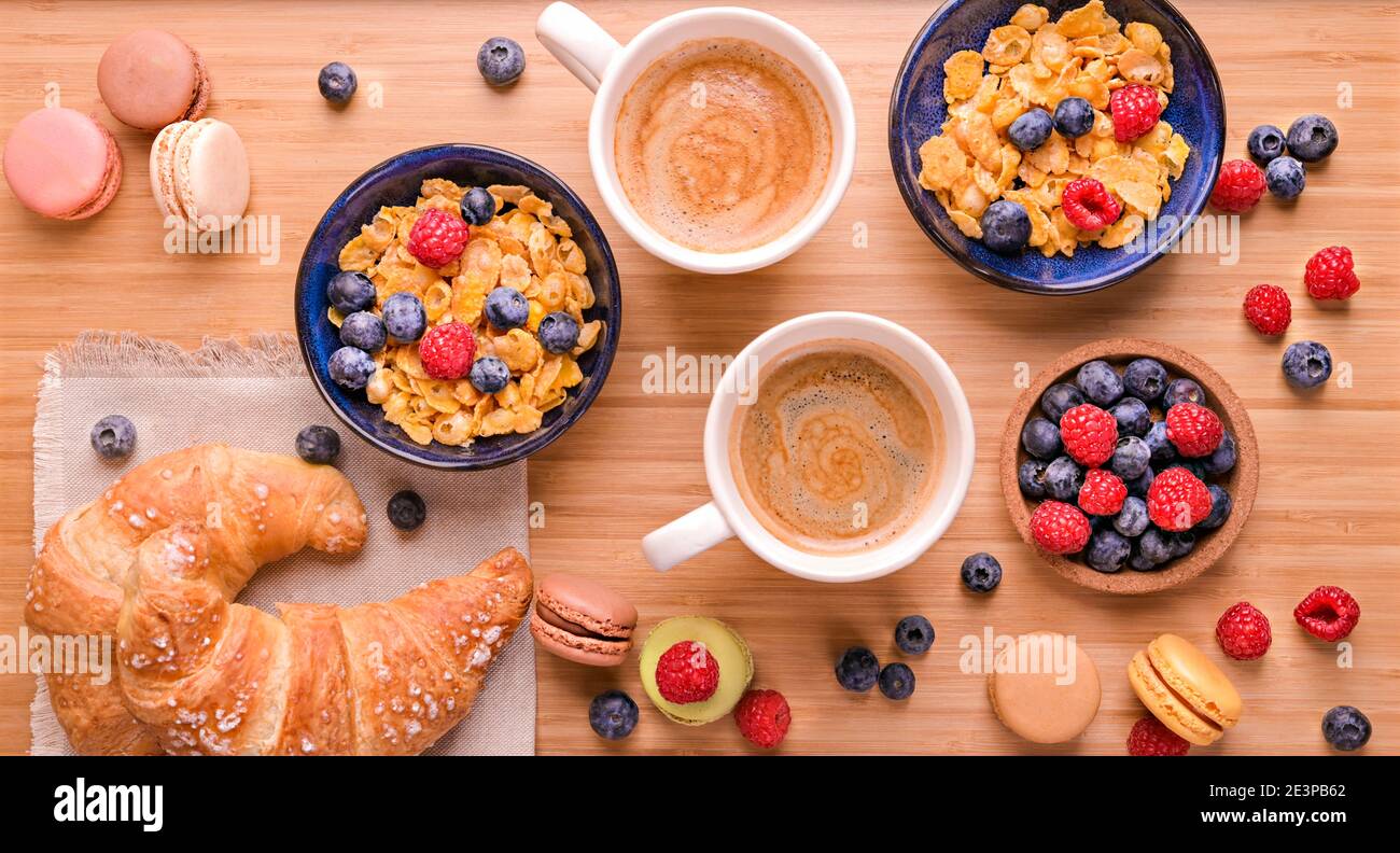 Aromatic coffee, muesli and sweet pastries for a romantic breakfast ...