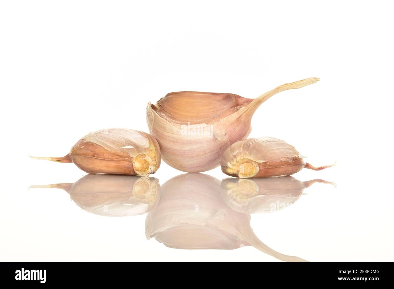 Three cloves of spicy fresh fragrant garlic on a white background Stock ...