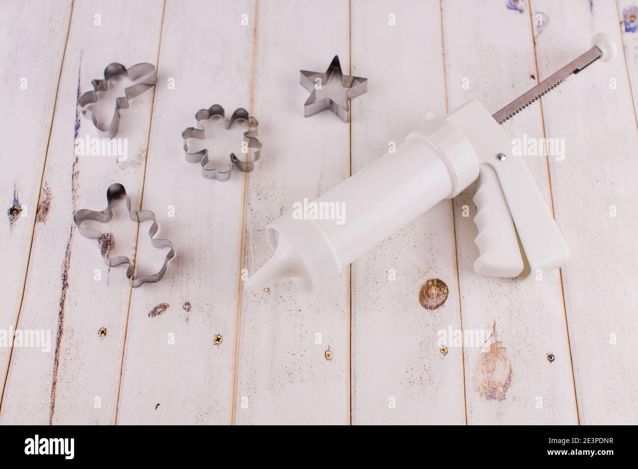 a pastry syringe with molds on wood background Stock Photo - Alamy