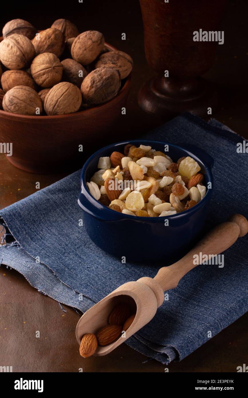 Whole and peeled walnuts in ceramic dishes on a dark background Stock ...