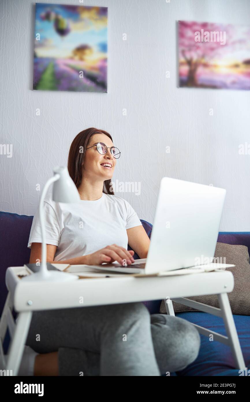Cheerful lady enjoying working offline at home Stock Photo - Alamy