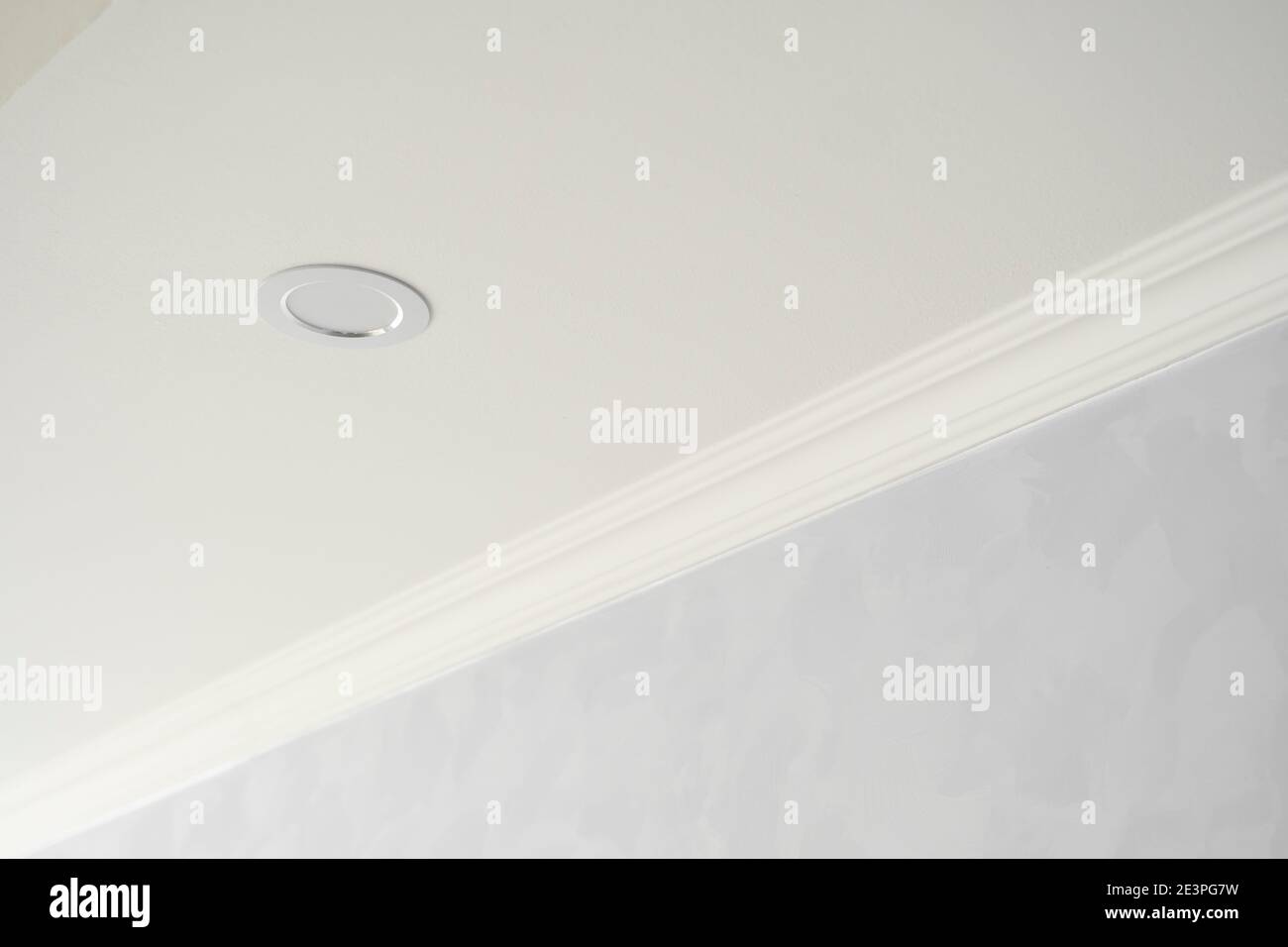 White ceiling with a white plinth in a room with gray painted walls ...