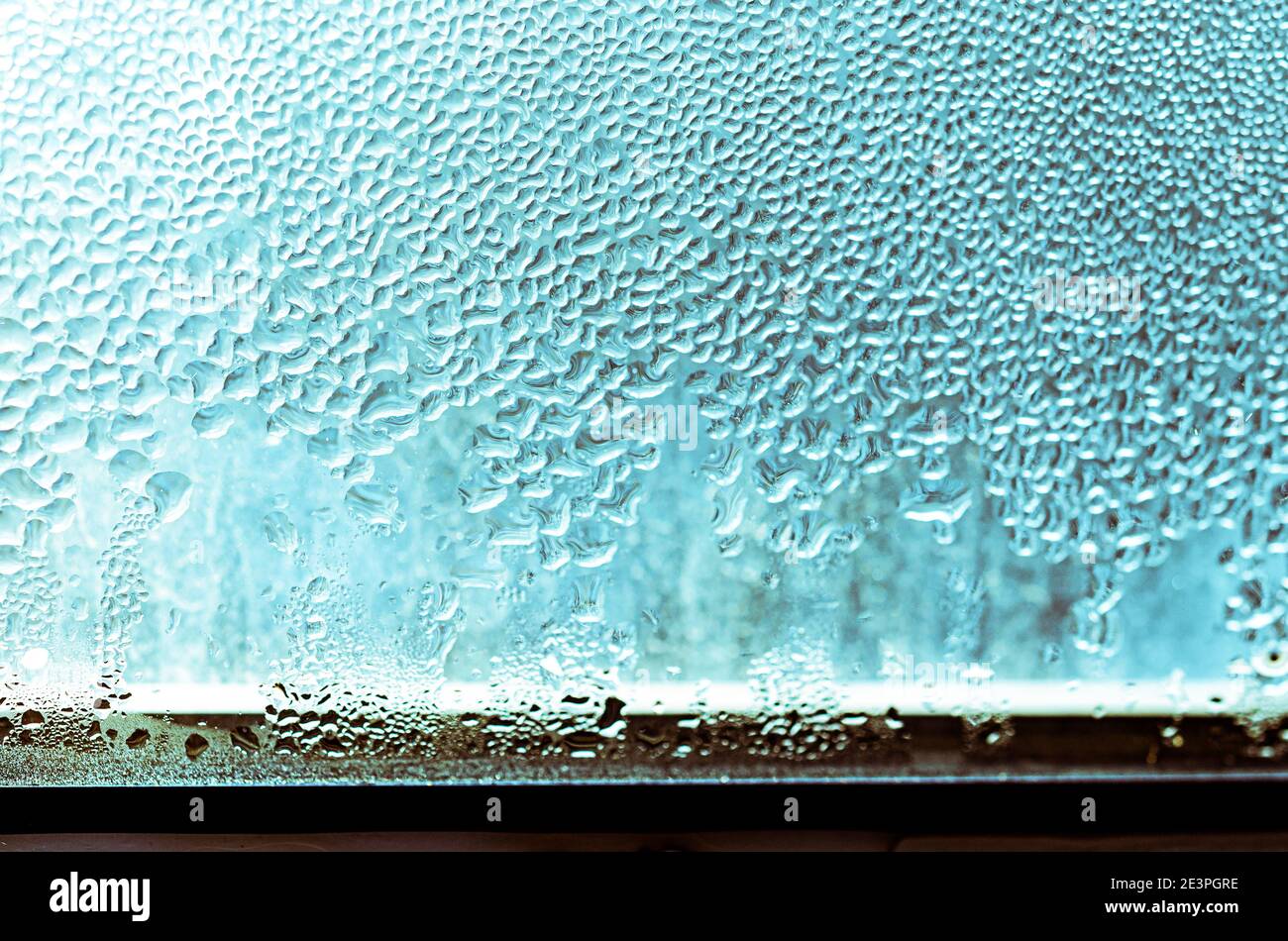 Large drops of condensate on a metal-plastic window. Dew point. Plastic ...