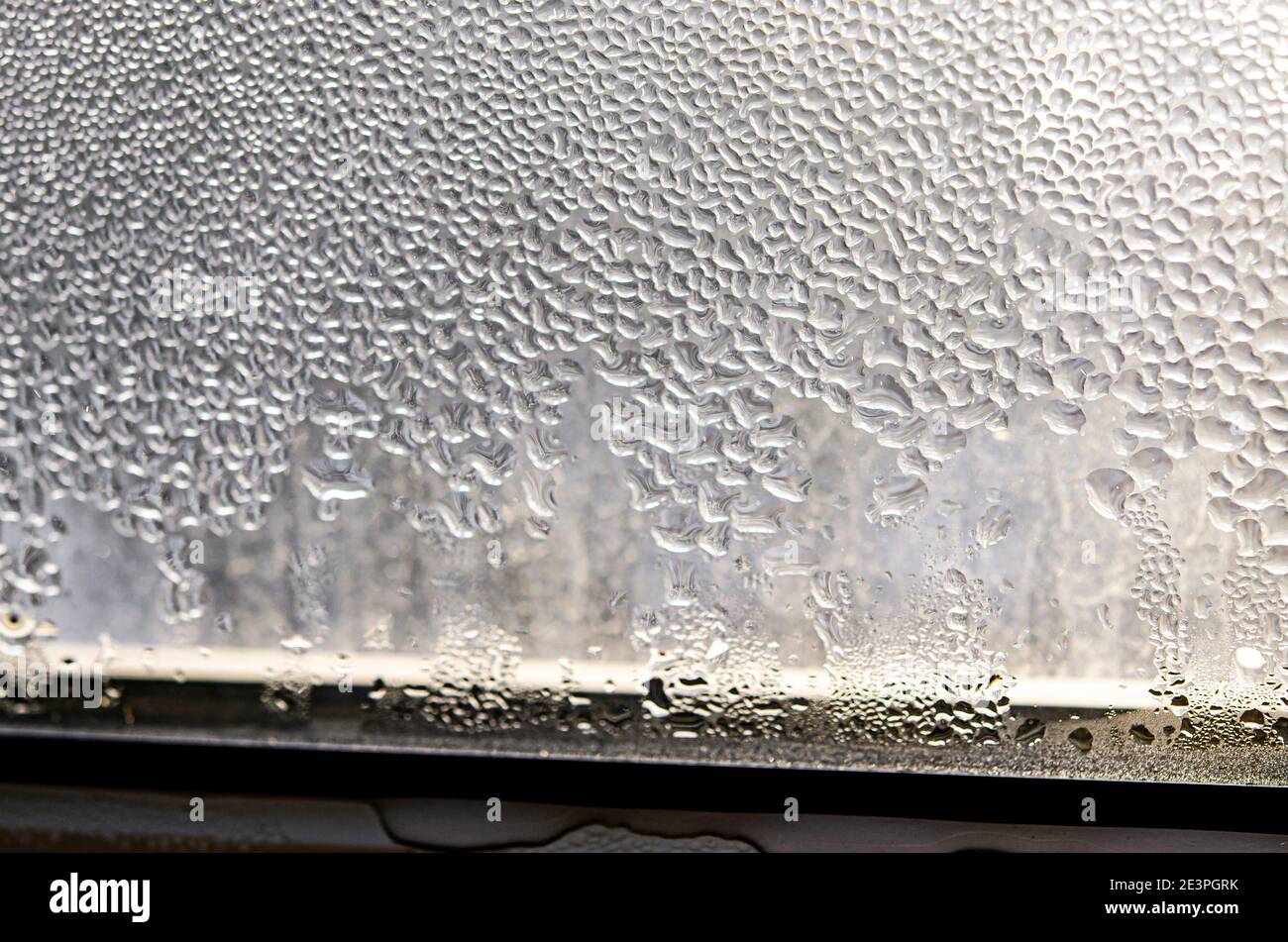 Large drops of condensate on a metal-plastic window. Dew point. Plastic ...