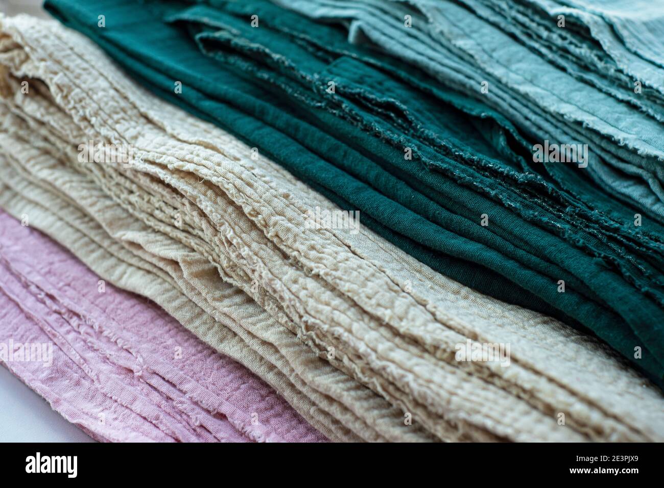 Creased, crinkled cotton cuts are stacked obliquely. Textile striped ...