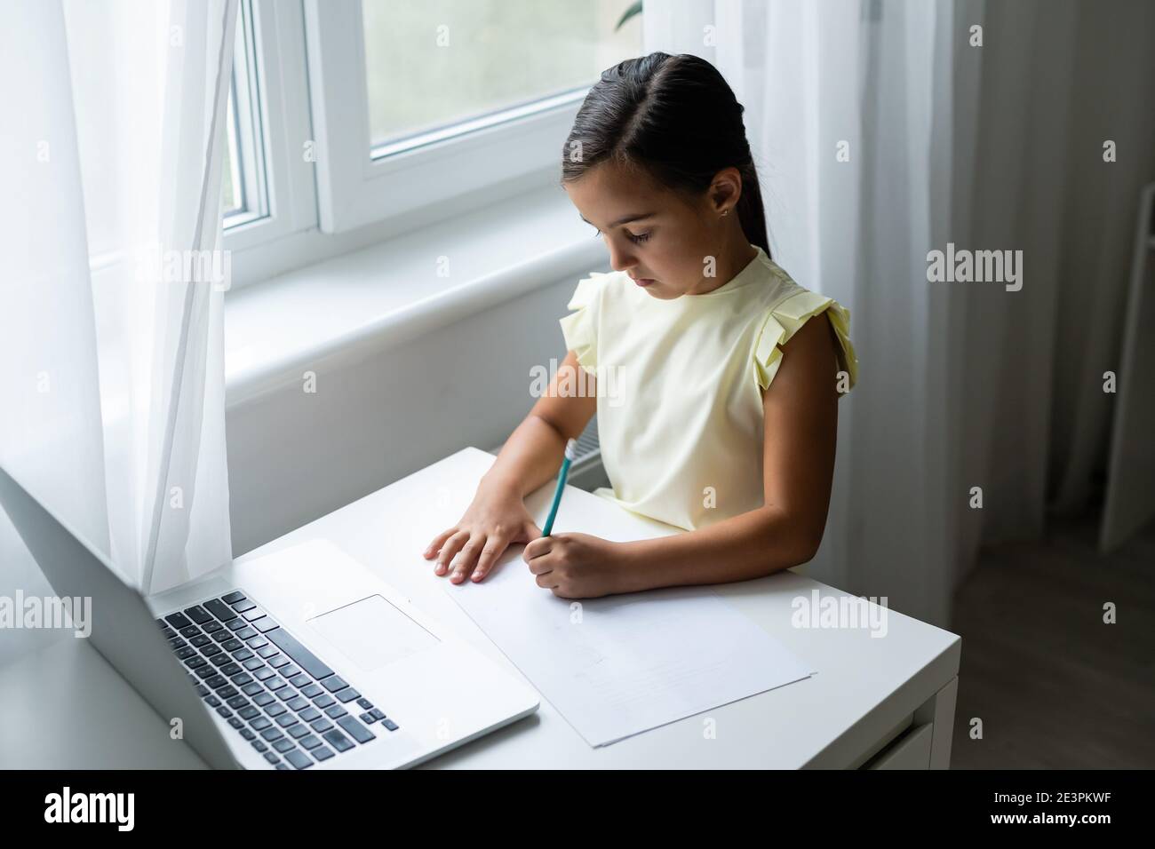 cheerful young little girl children using laptop computer, studying ...