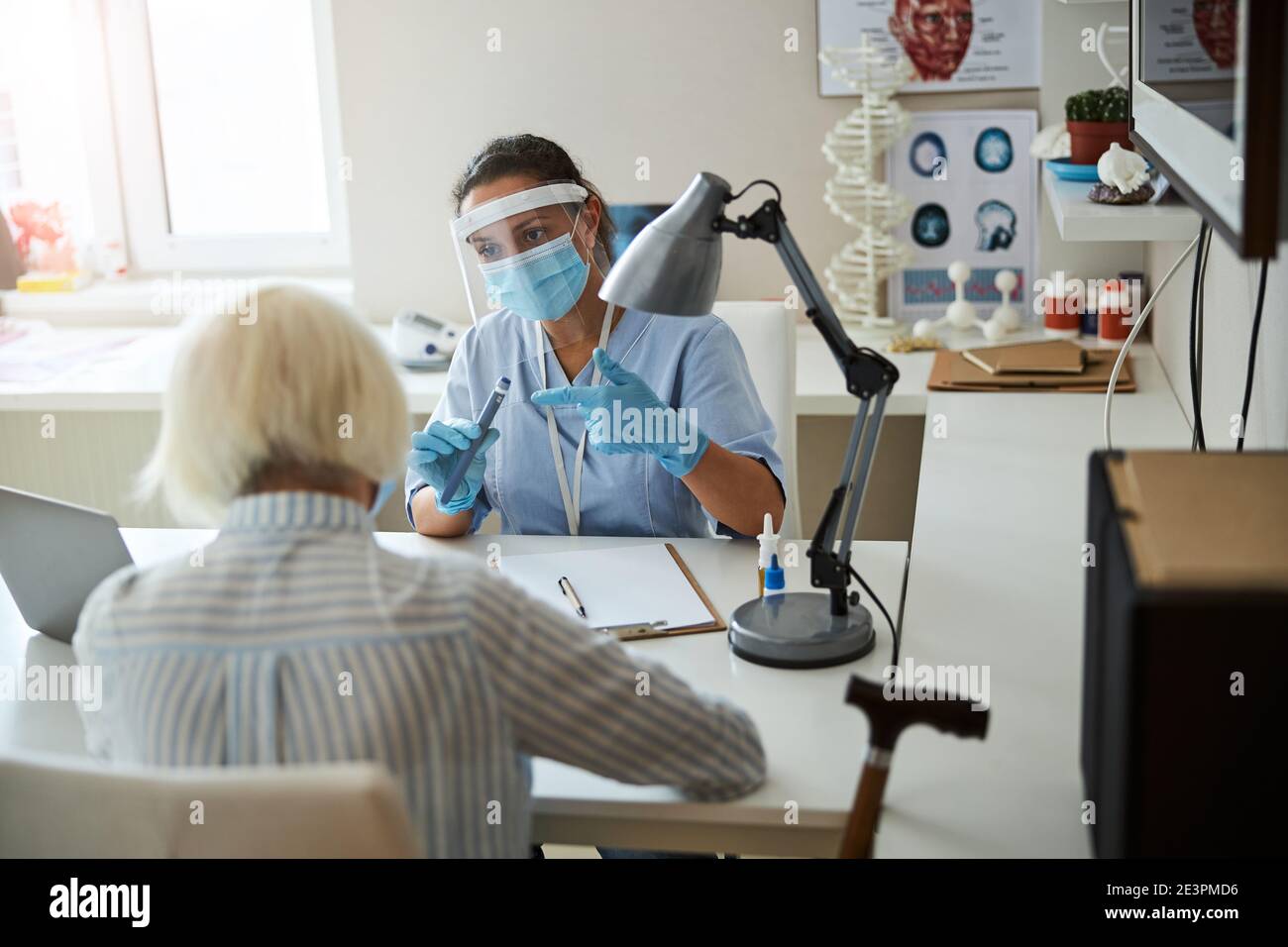 General practitioner explaining the using of a pen injector device ...