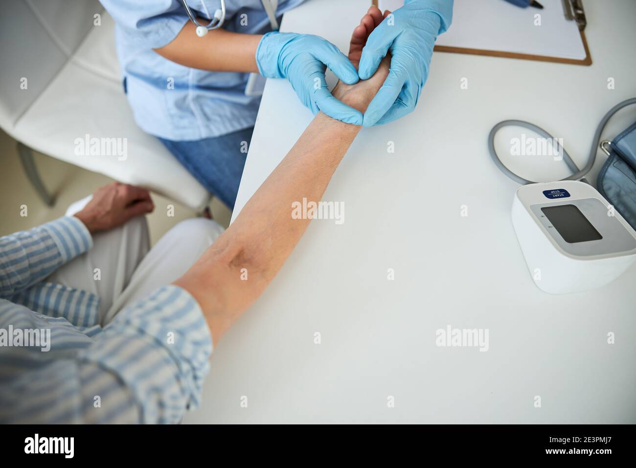 Woman taking pulse wrist hi-res stock photography and images - Alamy