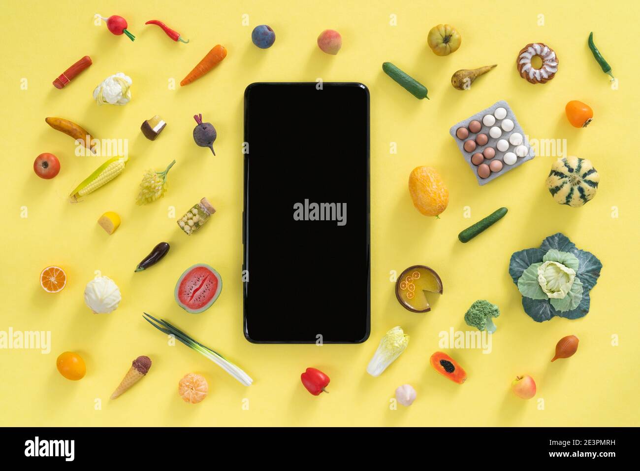 Online shopping concept - different foods and phone on yellow ...