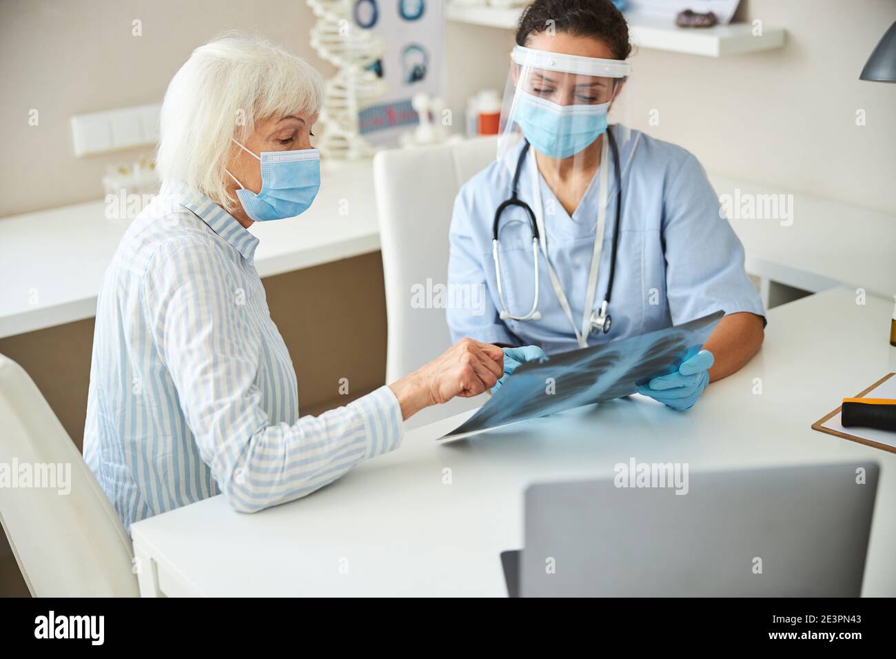 Medical person with a female pensioner watching a chest x-ray Stock ...