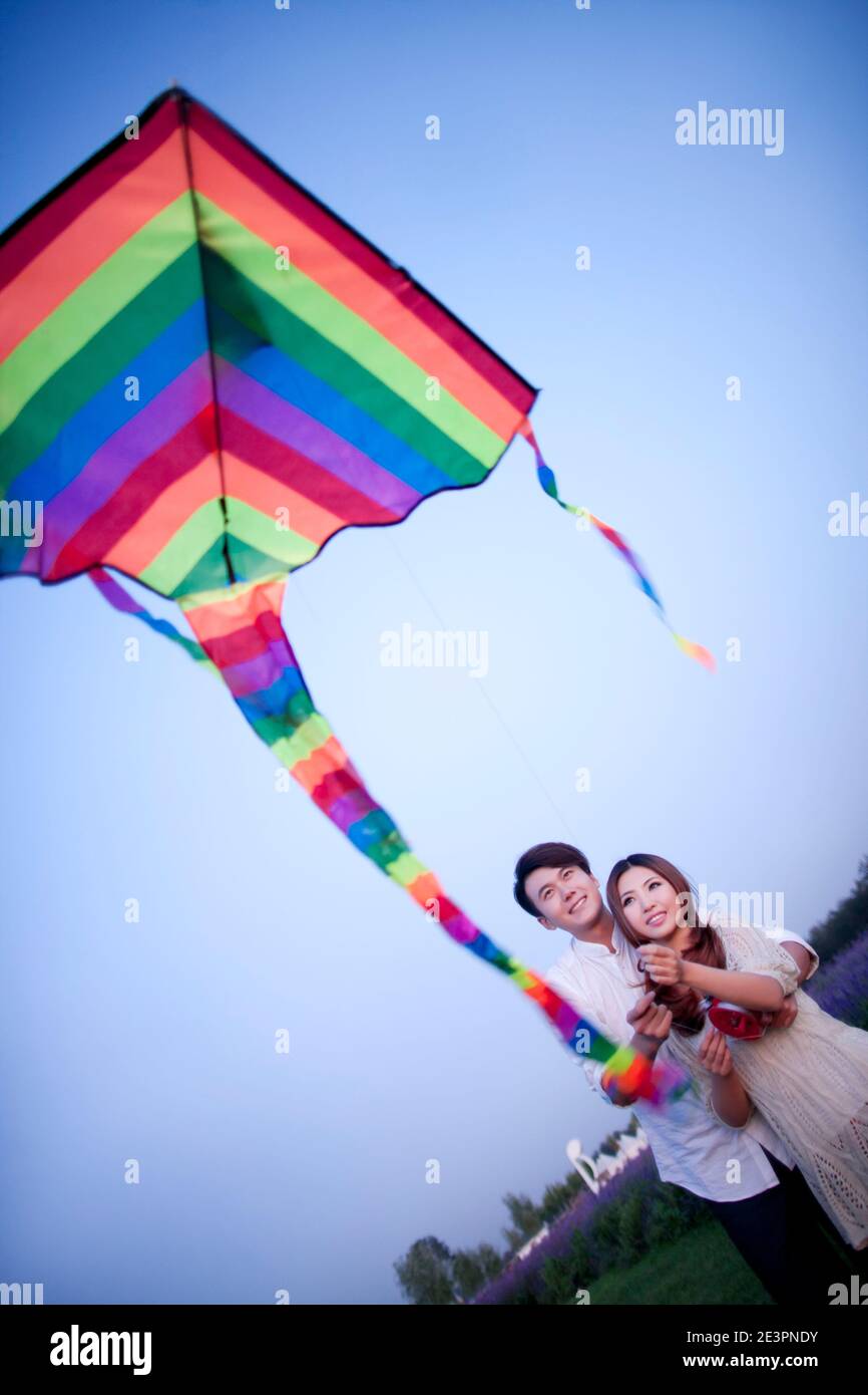 Young couple flying a kite hi-res stock photography and images - Alamy