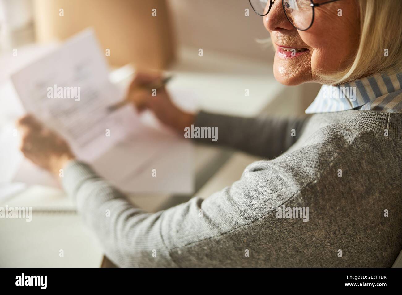 Old woman holding sheet of paper hi-res stock photography and images ...